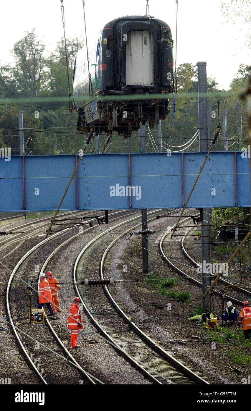 A carriage is lifted by a crane from the scene of rail crash at ...