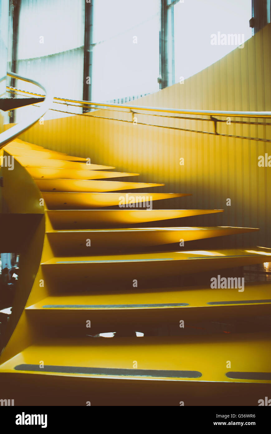 Photograph of a metal yellow abstract stairs Stock Photo - Alamy