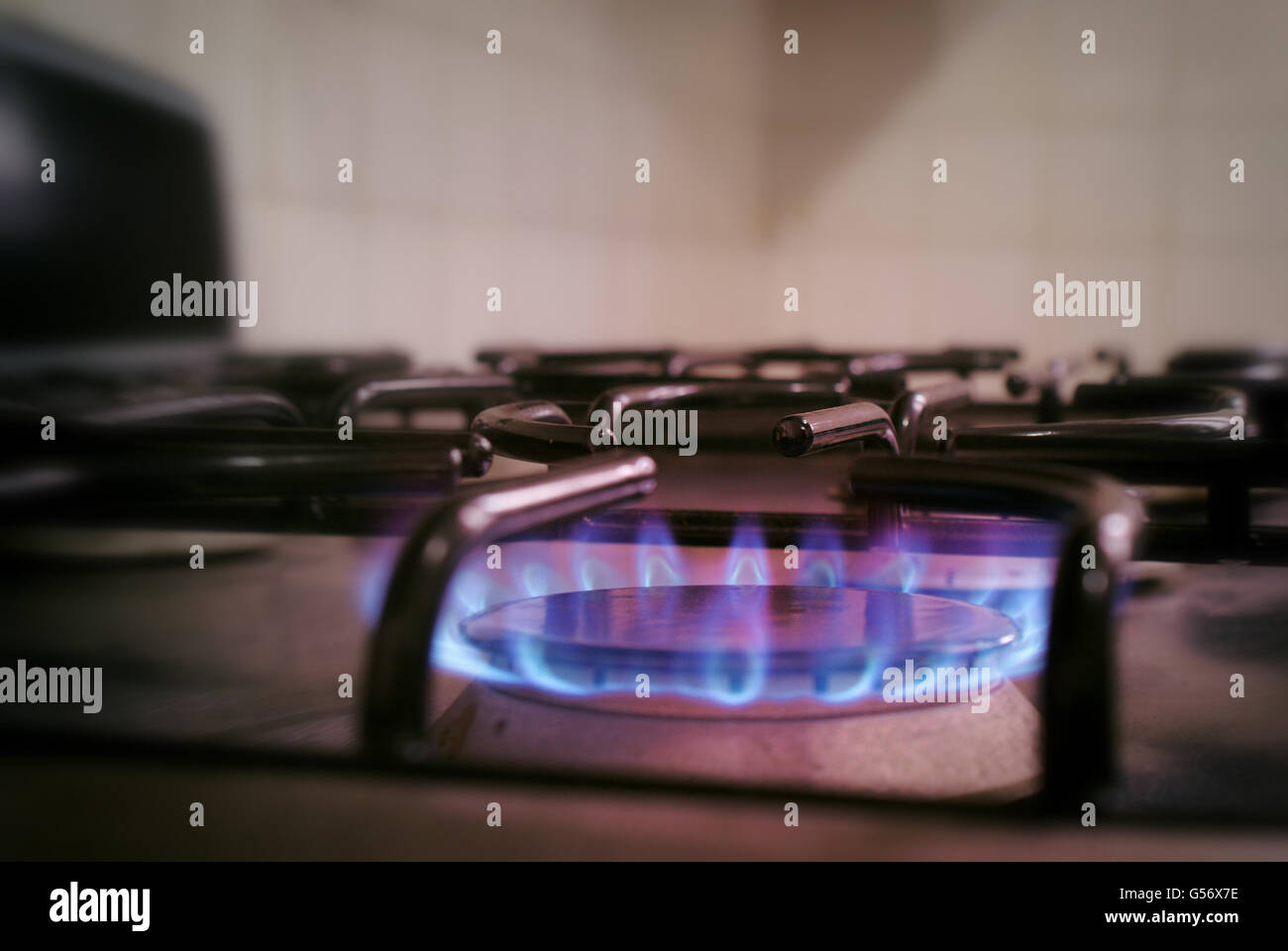 Photograph of a lighted metal gas stove and blue fire flame Stock Photo ...