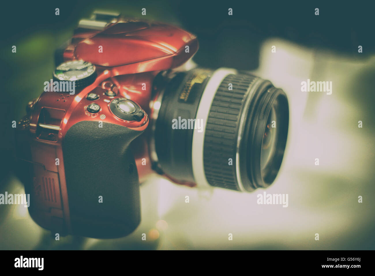 Photograph of a red reflex camera on a blurred background Stock Photo ...