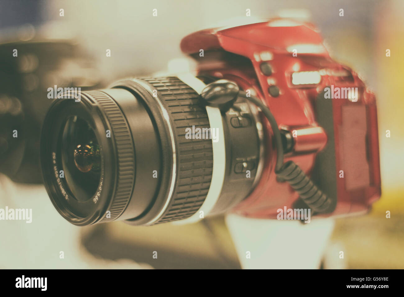 Photograph of a red reflex camera on a blurred background Stock Photo ...