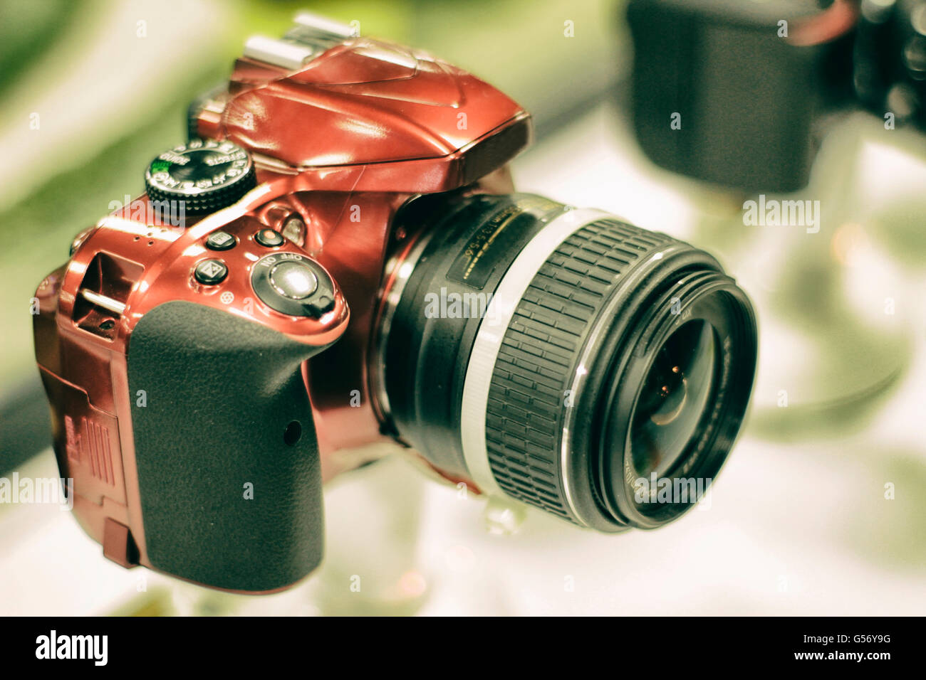 Photograph of a red reflex camera on a blurred background Stock Photo ...