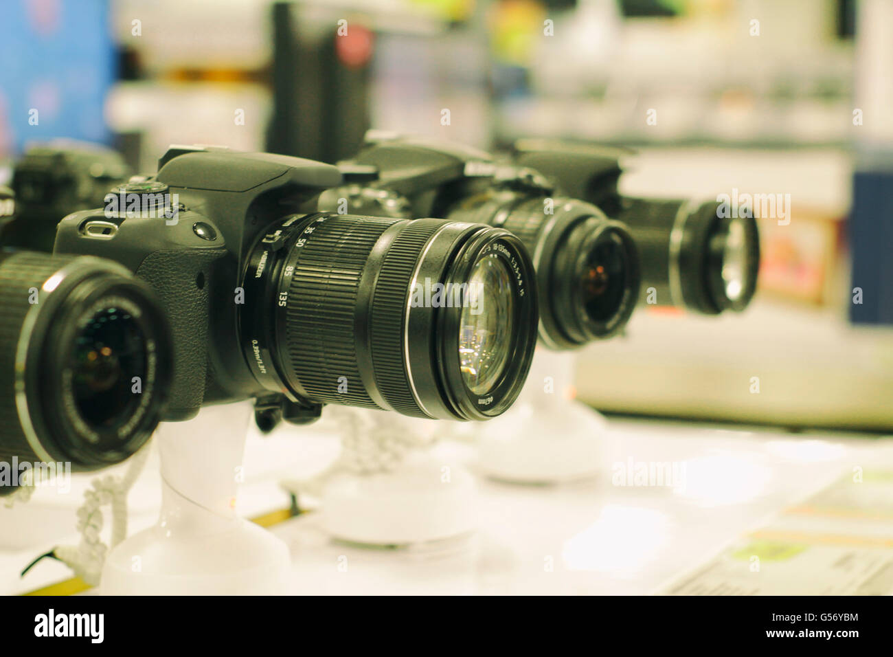 Photograph of some reflex cameras on a counter at a store and a blurred ...