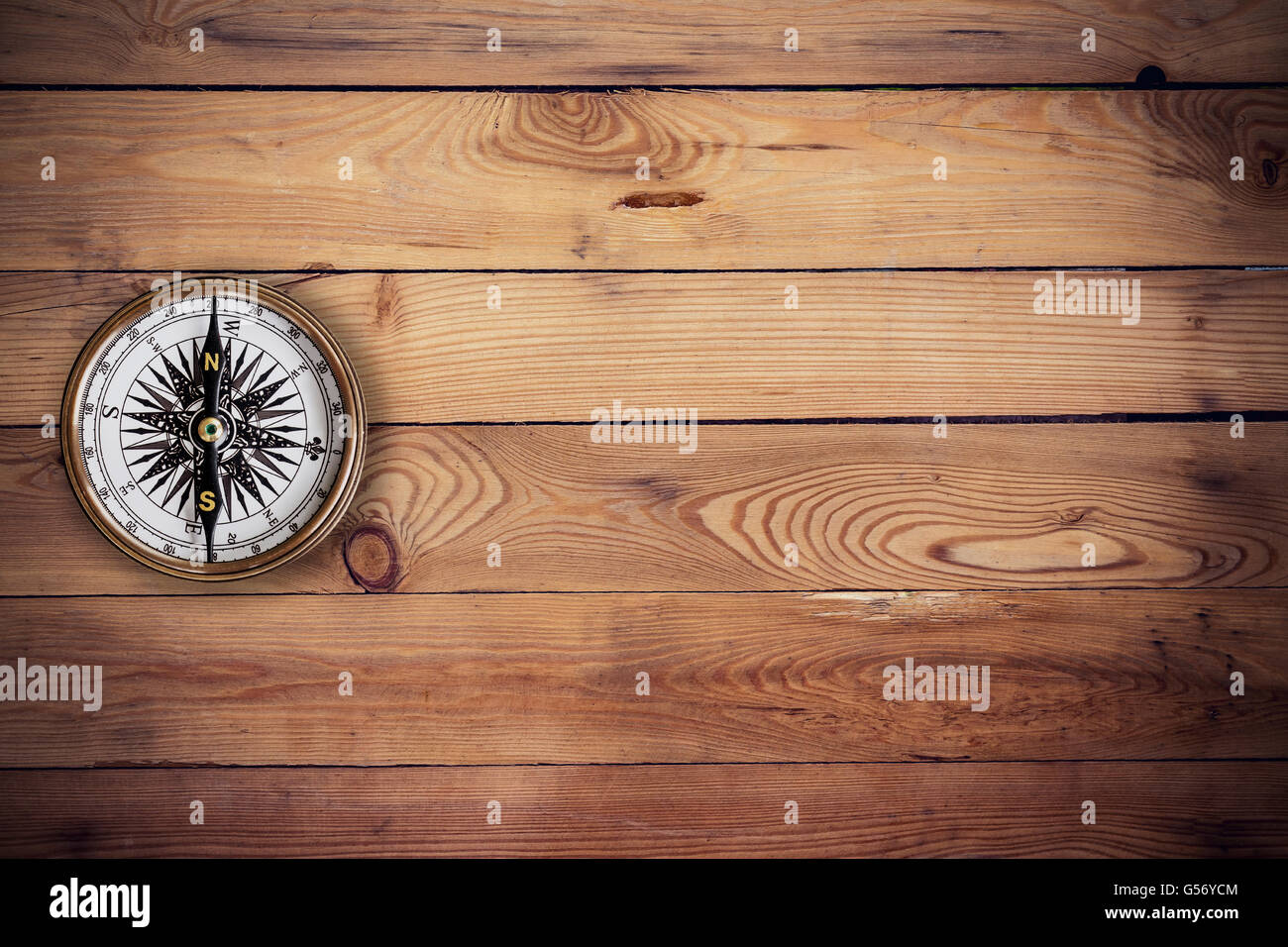 old compass on wood background and texture with space Stock Photo - Alamy