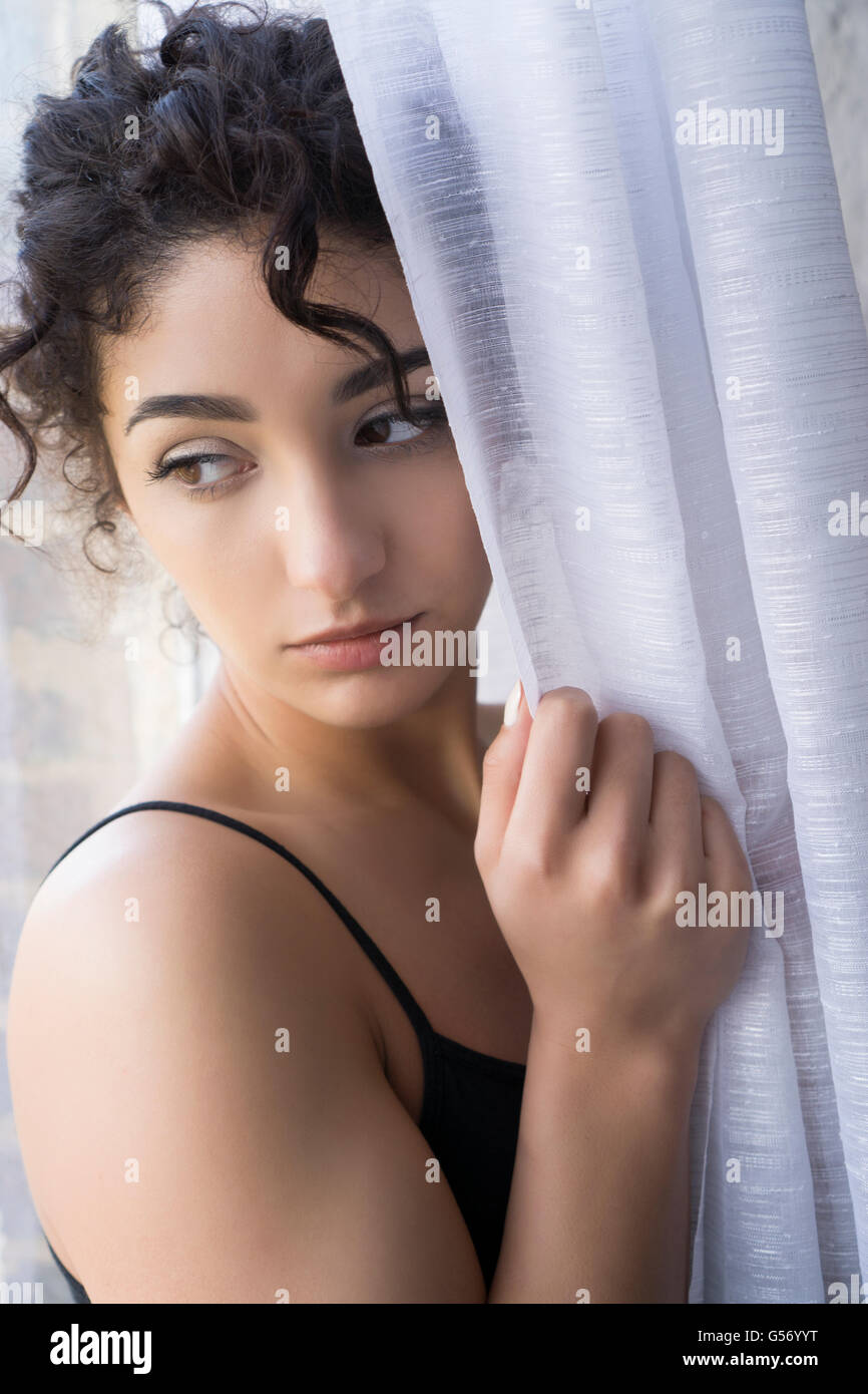 Sad woman by the window Stock Photo - Alamy