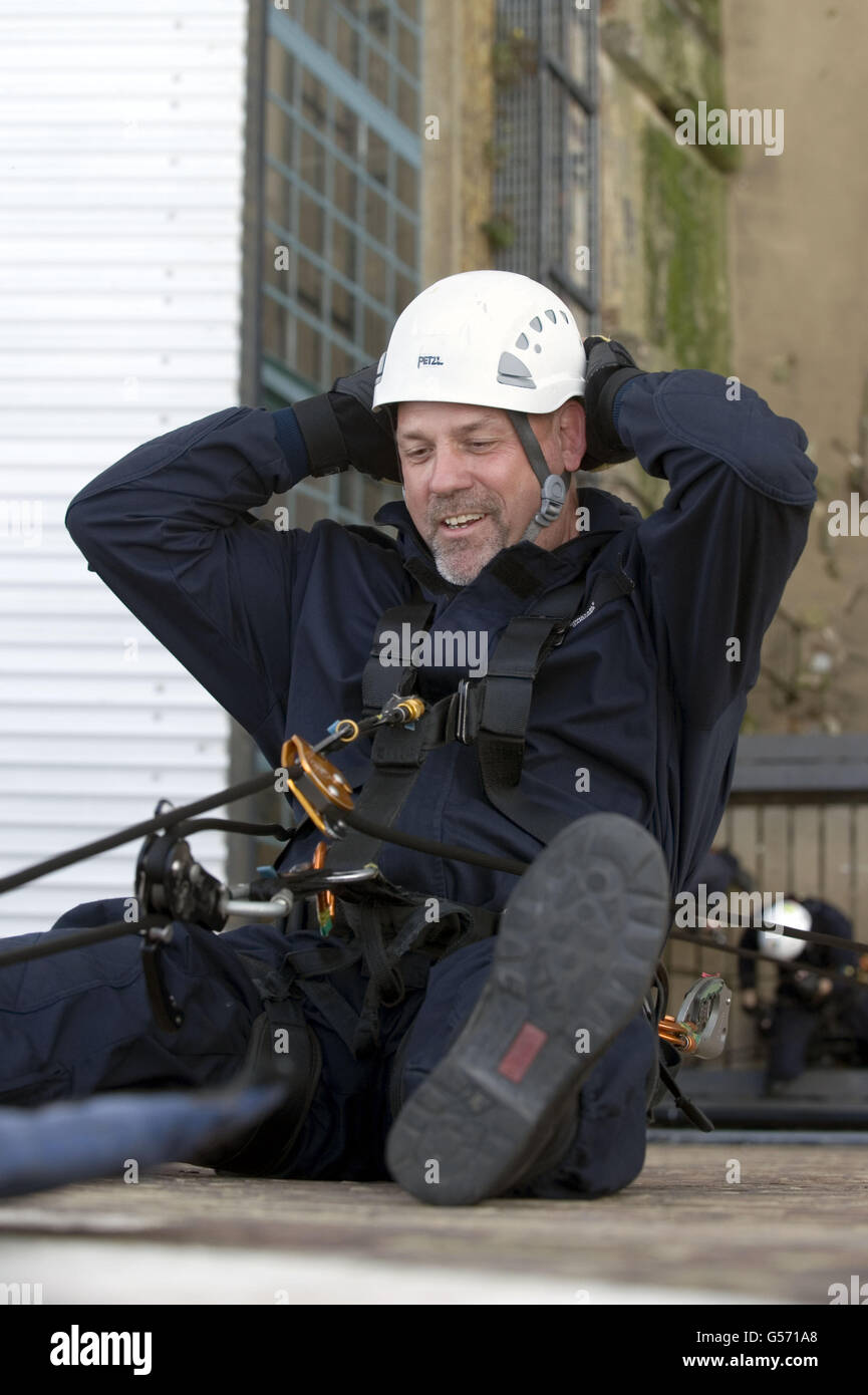 Metropolitan Police officer Andy Gardner practices abseiling techniques ...