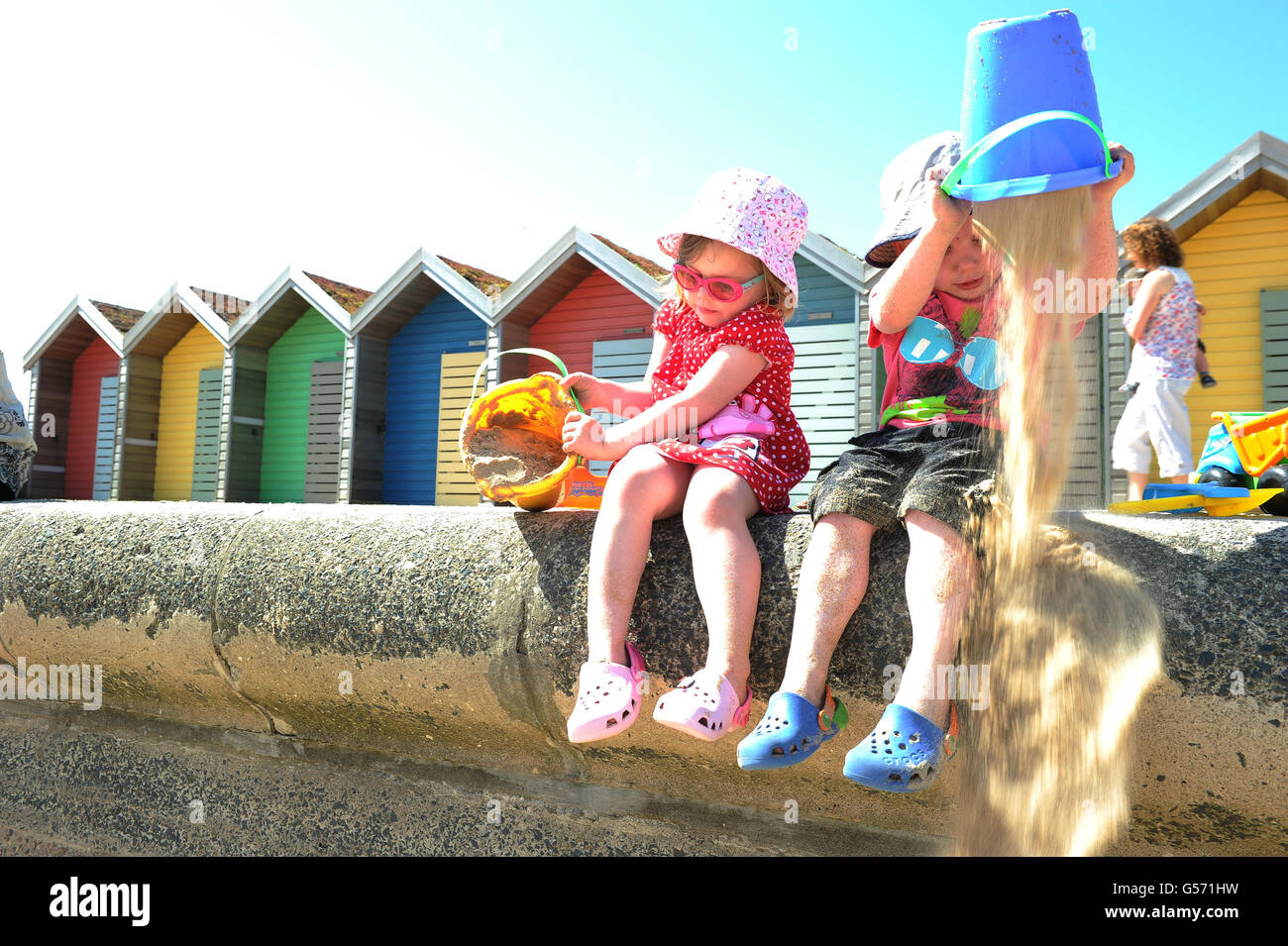 Cerys Scott, three, (left) and Corey Thompson, three, enjoy the sun at ...
