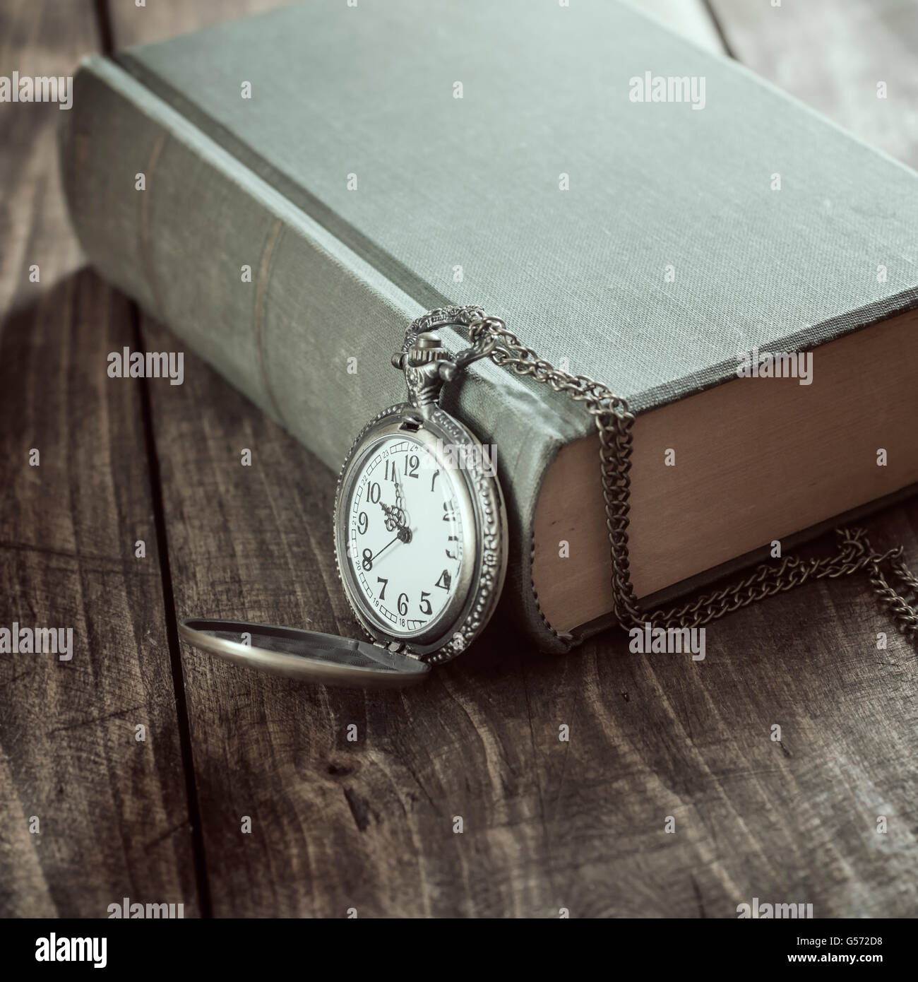Vintage pocket watch on old books. Close up photo Stock Photo - Alamy