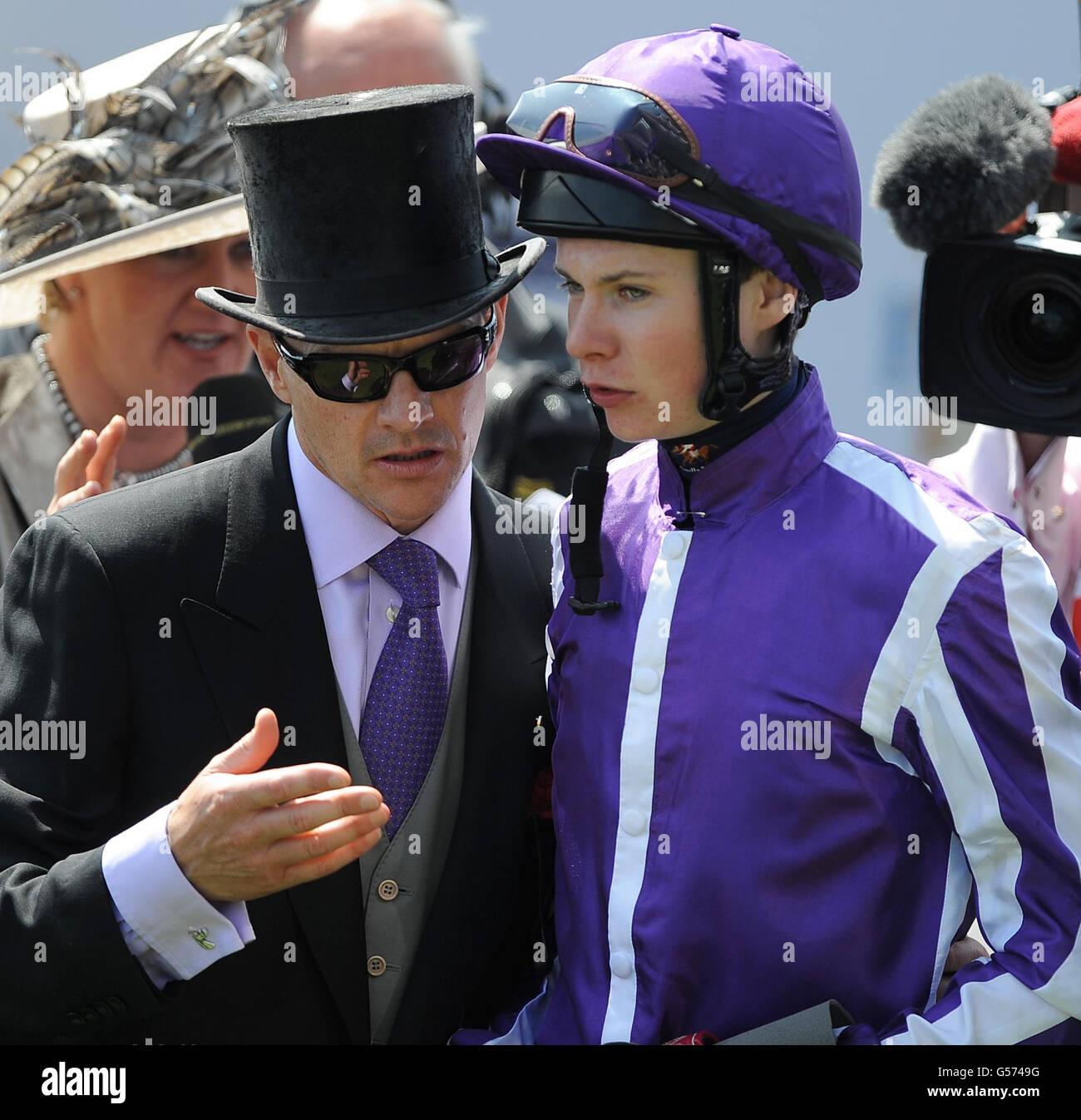 Trainer Aidan O'Brien (left) talks to his son and jockey Joseph O'Brien ...