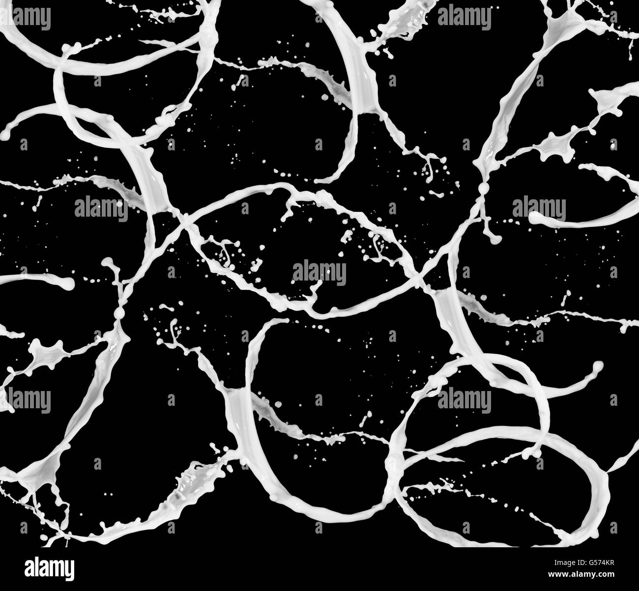 Milk splashes isolated on black background Stock Photo - Alamy