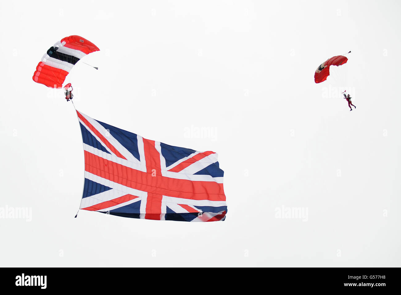 A member of the Red Devils parachute display team trails a Union flag ...