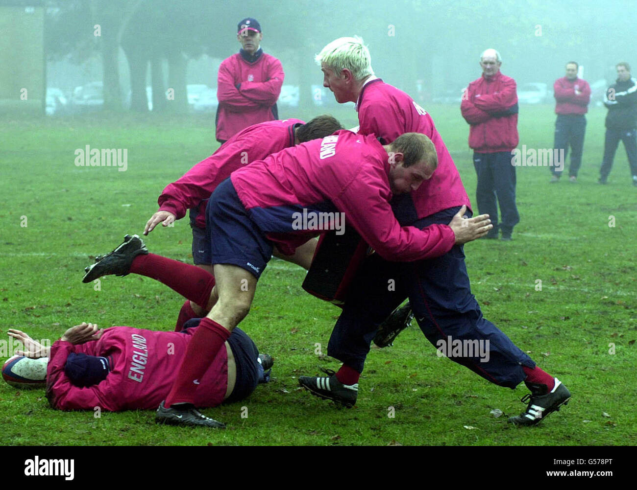 England rugby union coach Clive Woodward (baseball cap) watches as ...