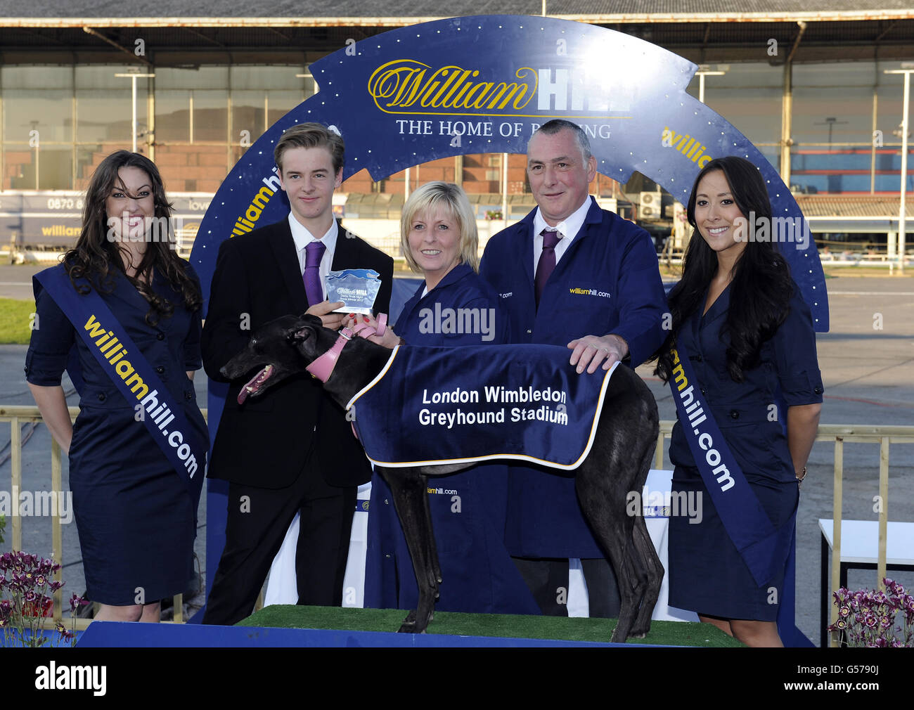 The connections of a winning greyhound celebrate at Wimbledon Greyhound ...