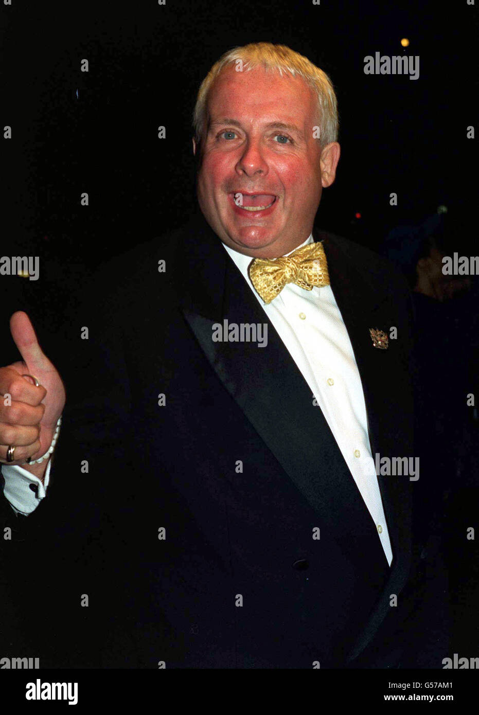 Smiling celebrity mouth open thumbs up gold bow tie tuxedo hi-res stock ...