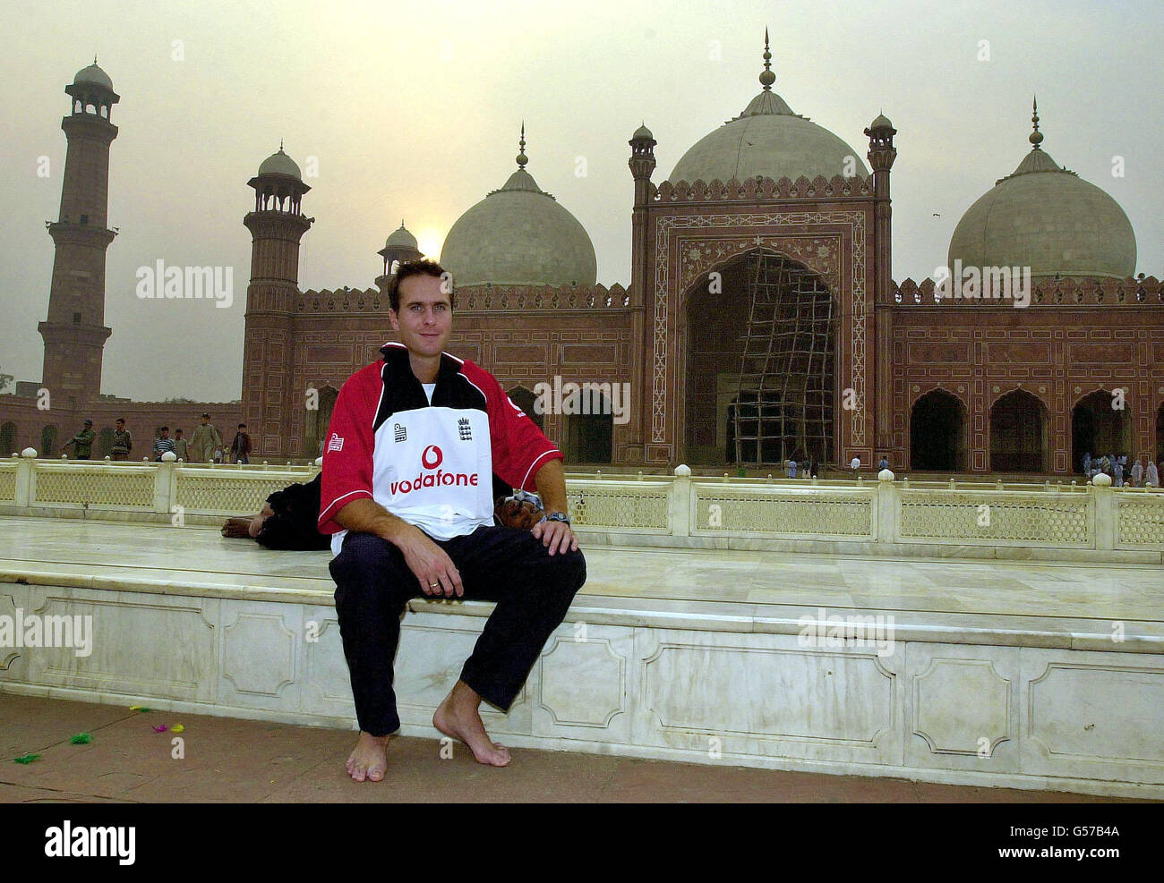 England cricketer Michael Vaughan sits in front of the Badshahi Mosque ...