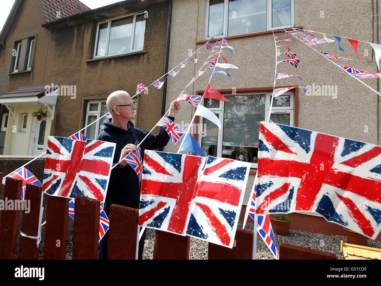 William Rattray puts up Flags in his garden in Fallin, Central Scotland ...