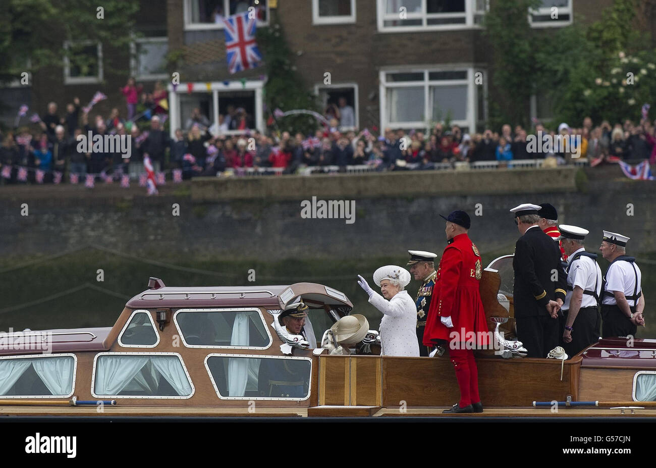 Queen Elizabeth II waves from the Royal Yacht Britannia's Royal Barge ...