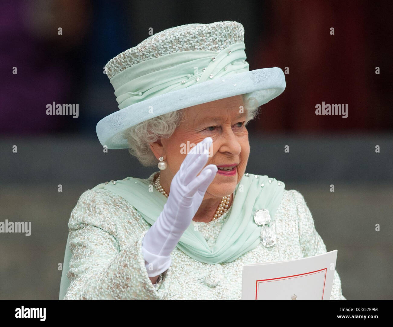 Queen Elizabeth II waves to the crowd as she leaves following a service ...