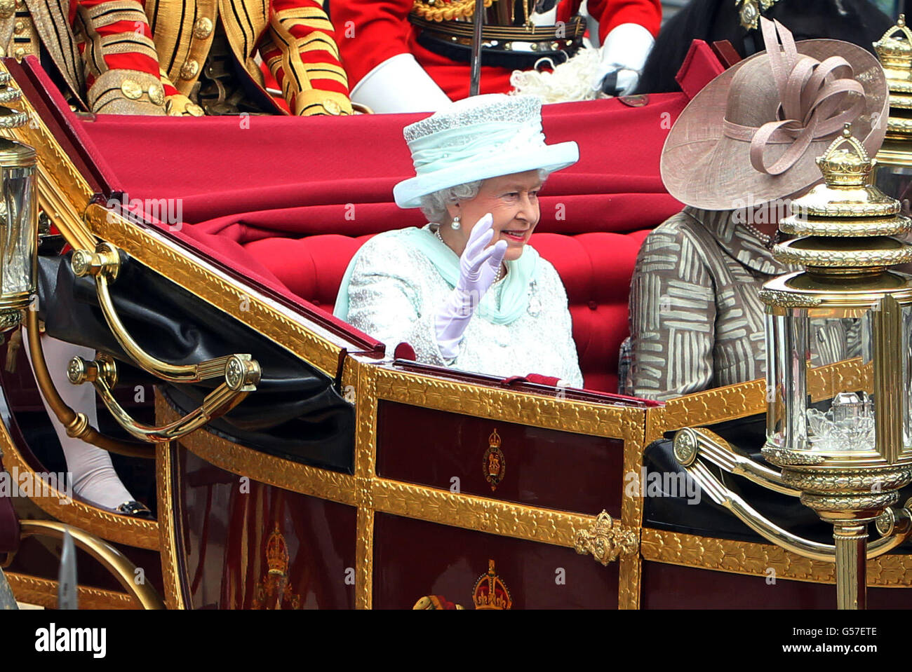 Queen Elizabeth II in her carriage on her way back to Buckingham Palace ...