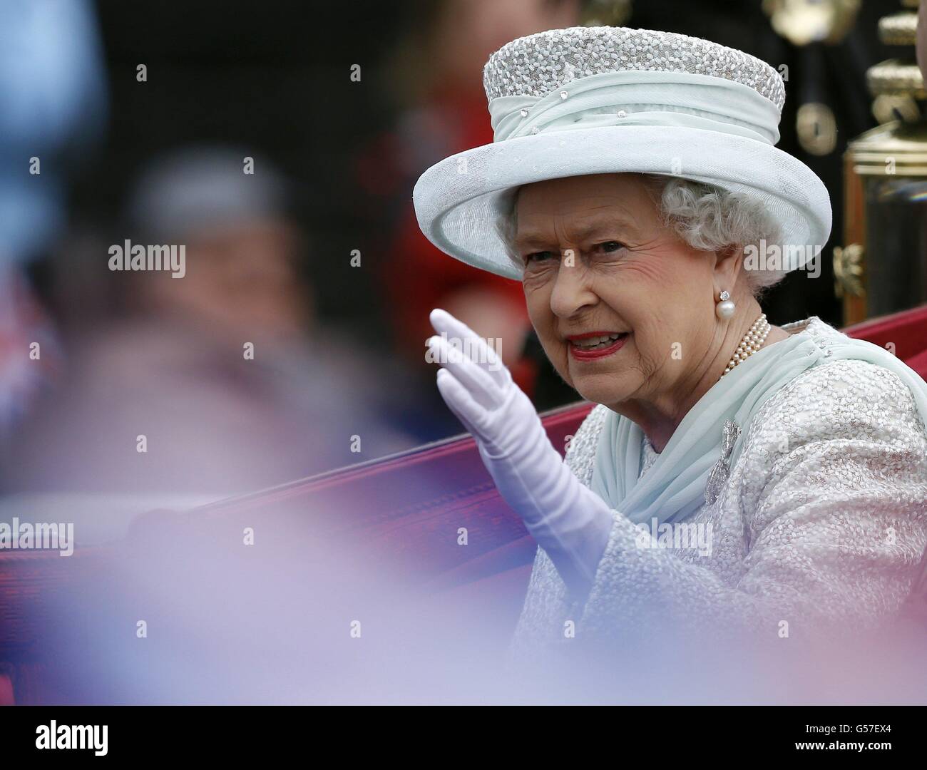 Queen Elizabeth II waves to spectators as she leaves Westminster Hall ...