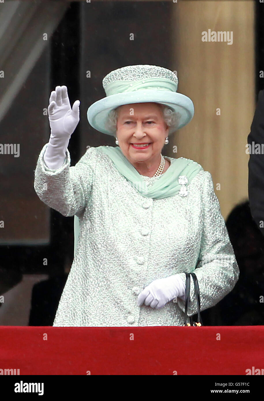 Queen Elizabeth II waves to the public as she appears on the balcony of ...