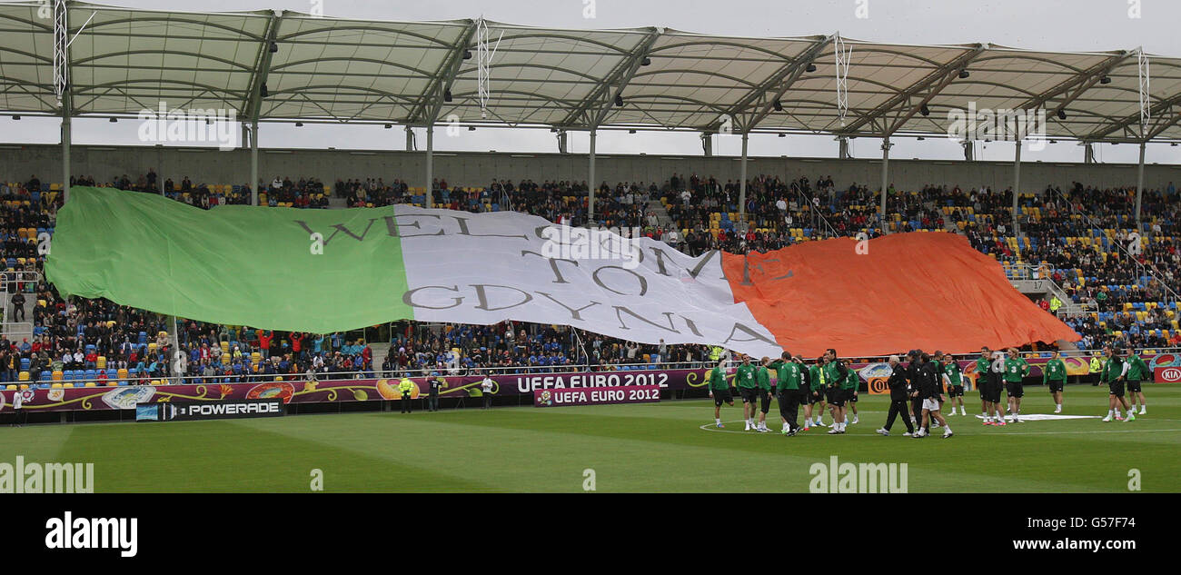 A large flag with the words "Welcome to Gdynia" is unveiled during team ...