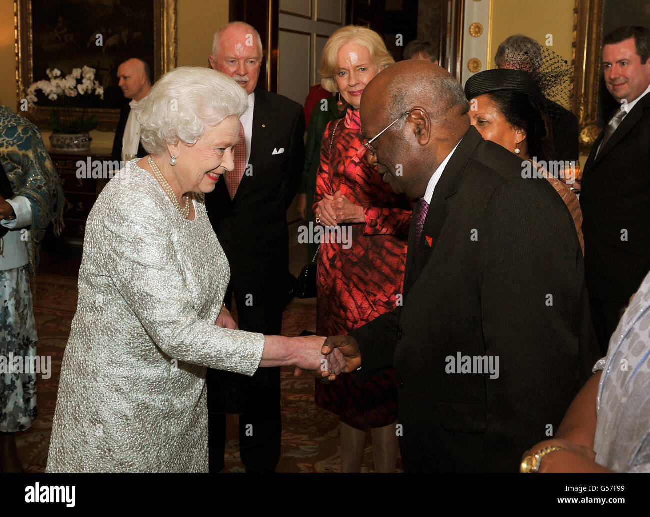 Queen Elizabeth II shakes hands with Sir Michael Ogio the Governor ...