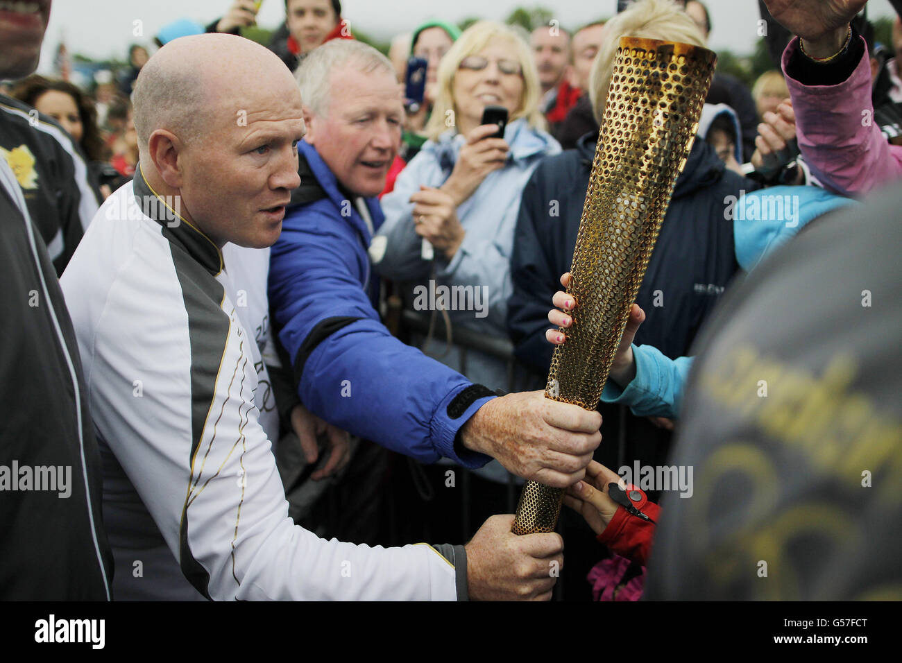 Olympic Boxer Michael Carruth holds the Olympic Torch on the border ...
