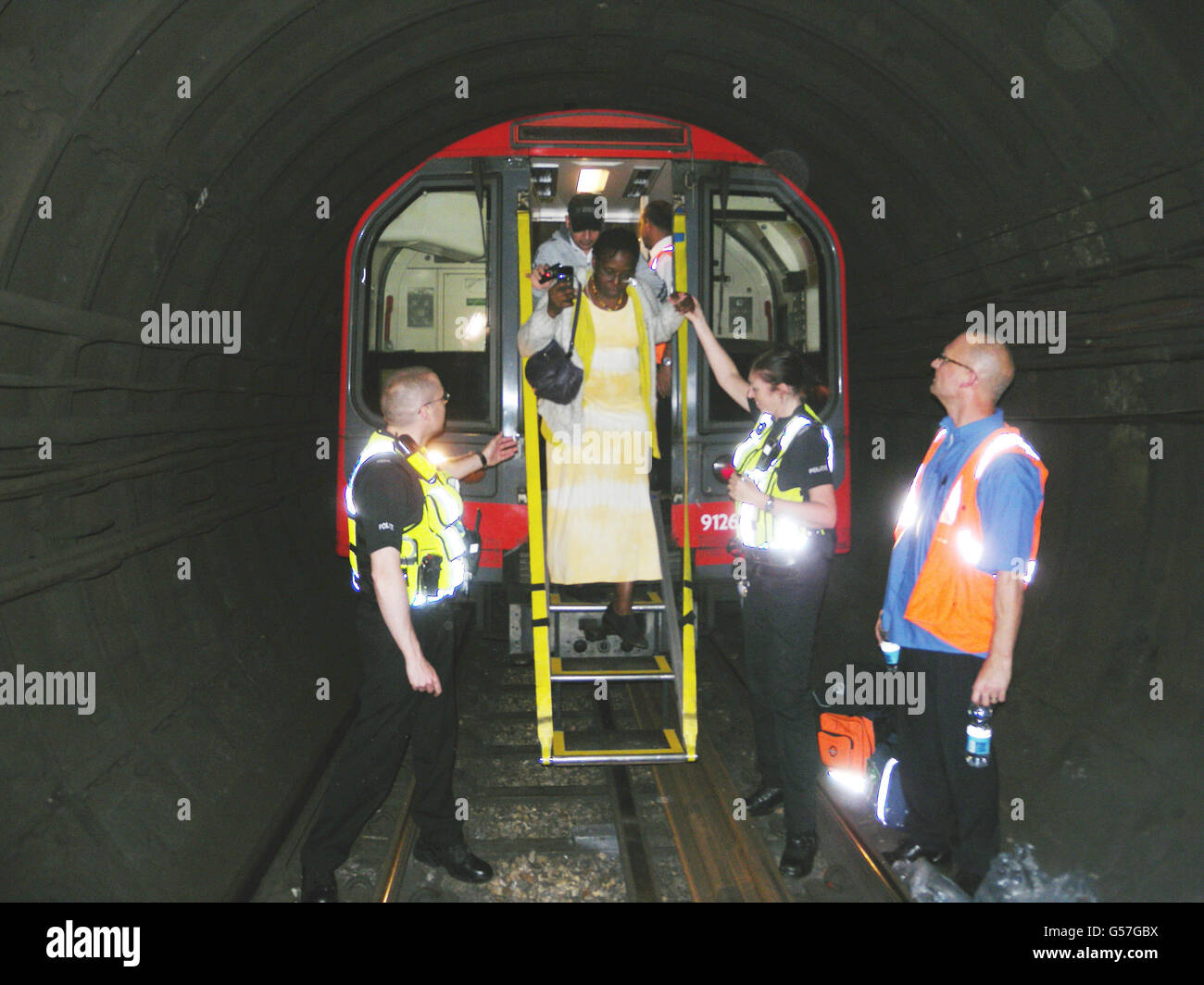 Passengers are helped from a stranded Central Line train between ...
