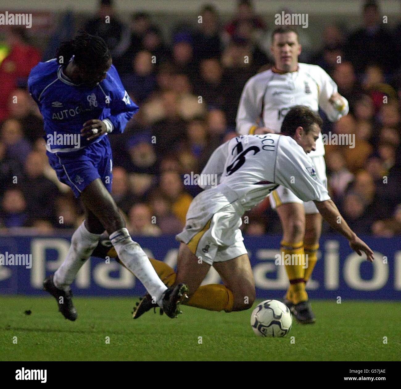 Chelsea's Mario Melchiot (left) tackles Bradford City's Dan Petrescu ...