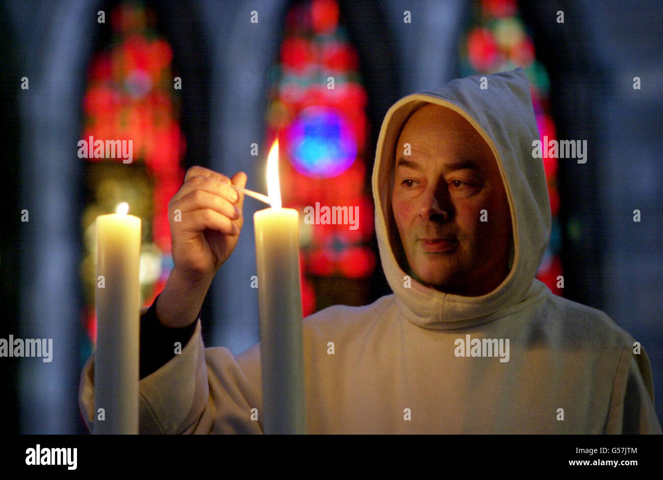 Father Giles lights a candle before Christmas Service at Pluscarden ...