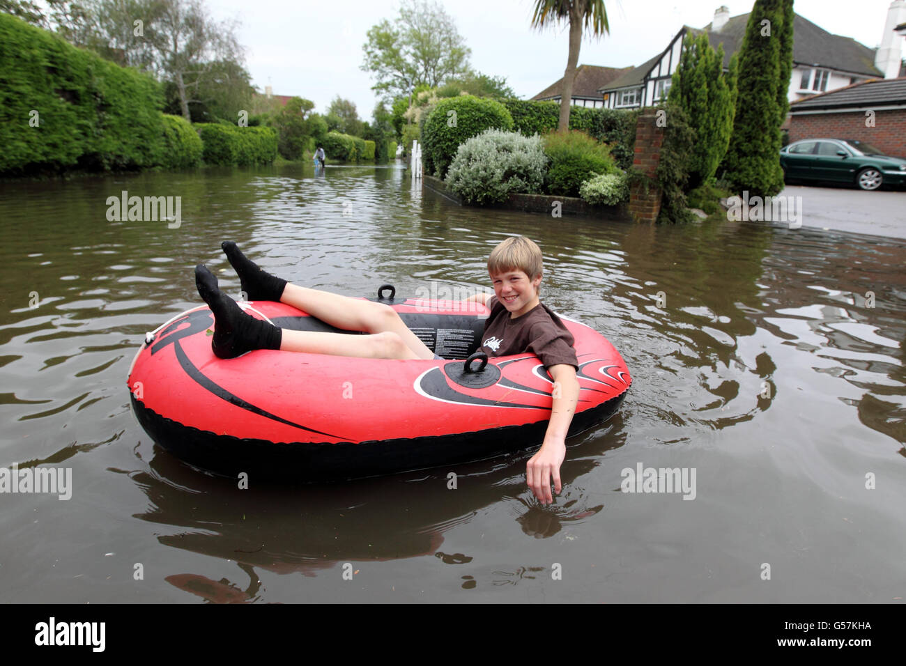 A boy plays in a dingy along a flooded road in Felpham near Bognor ...