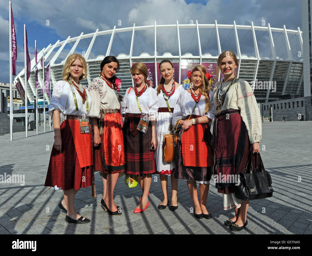 Local women in traditional costume pose outside the Olympic Stadium ...