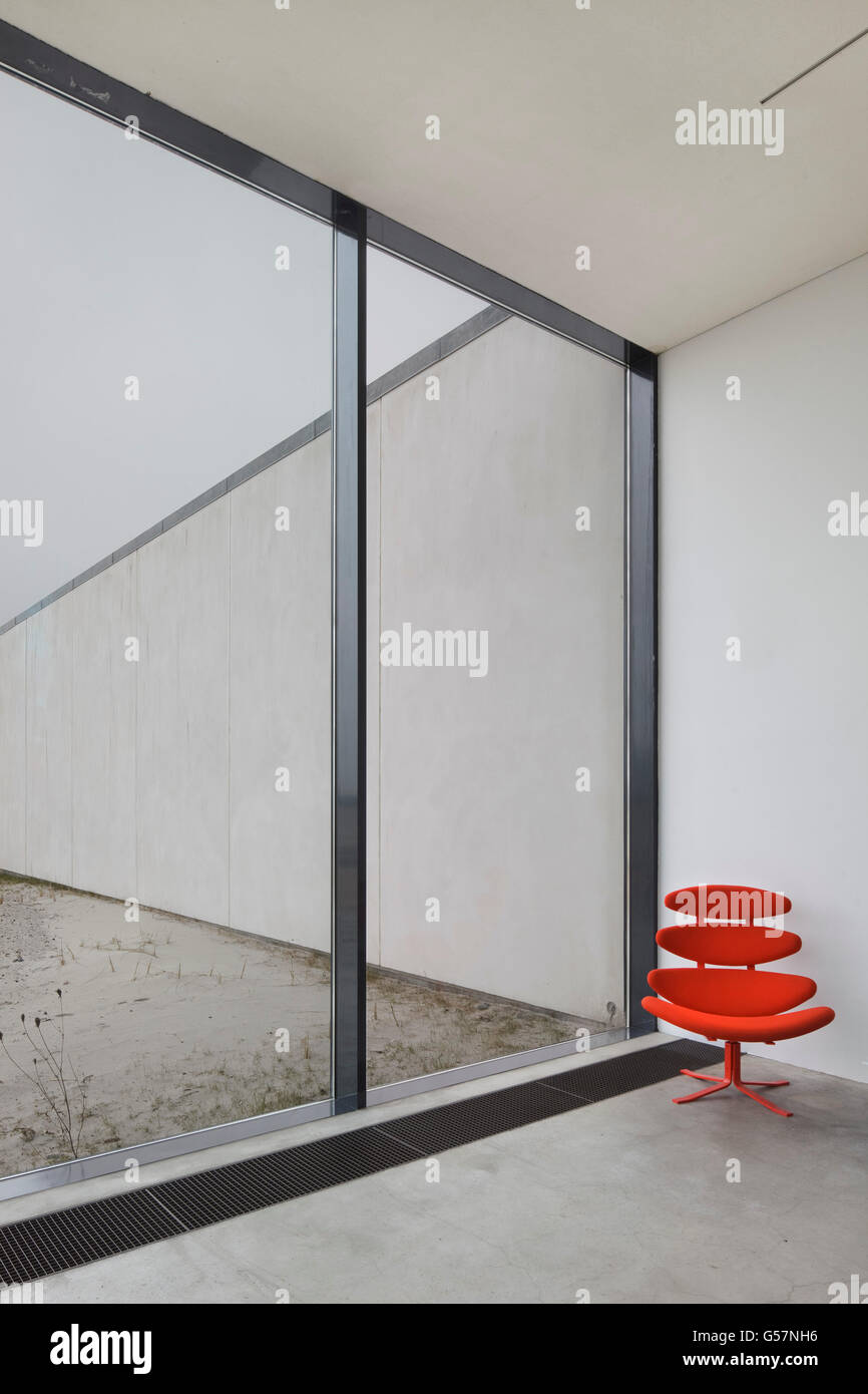 Floor-to-ceiling gallery window with orange chair. ARKEN Museum of ...