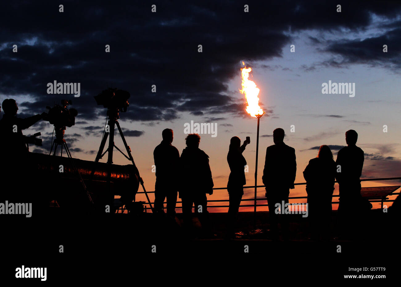 People view the Diamond Jubilee beacon at Edinburgh Castle beside Mons ...