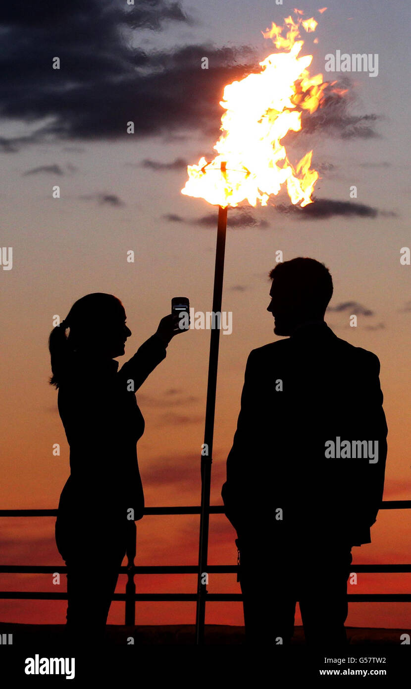 People view the Diamond Jubilee beacon at Edinburgh Castle beside Mons ...