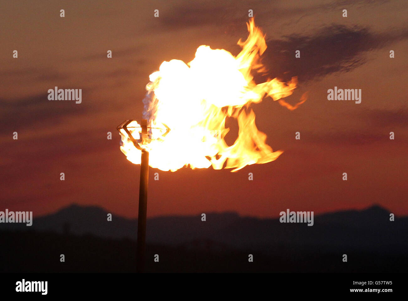 The Diamond Jubilee beacon burns at sunset at Edinburgh Castle beside ...