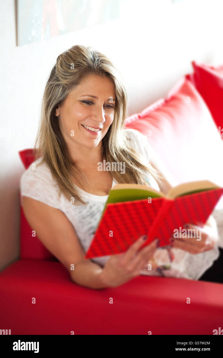 Seated Woman With A Book Seated Woman With A Book Hi Res Stock