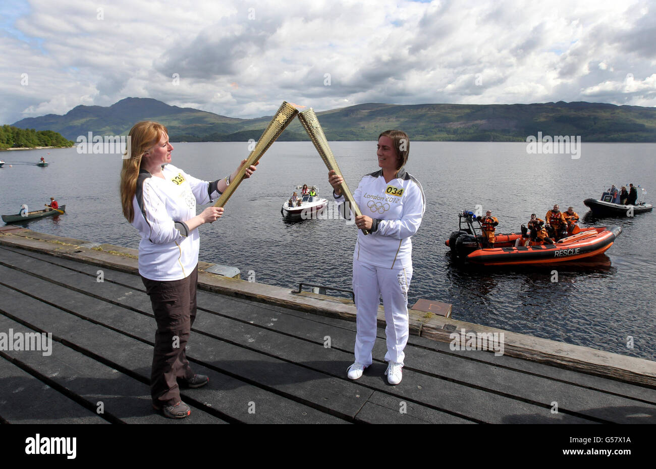 Olympic torchbearer Ruth Leith hands over the Olympic flame to Sheila ...