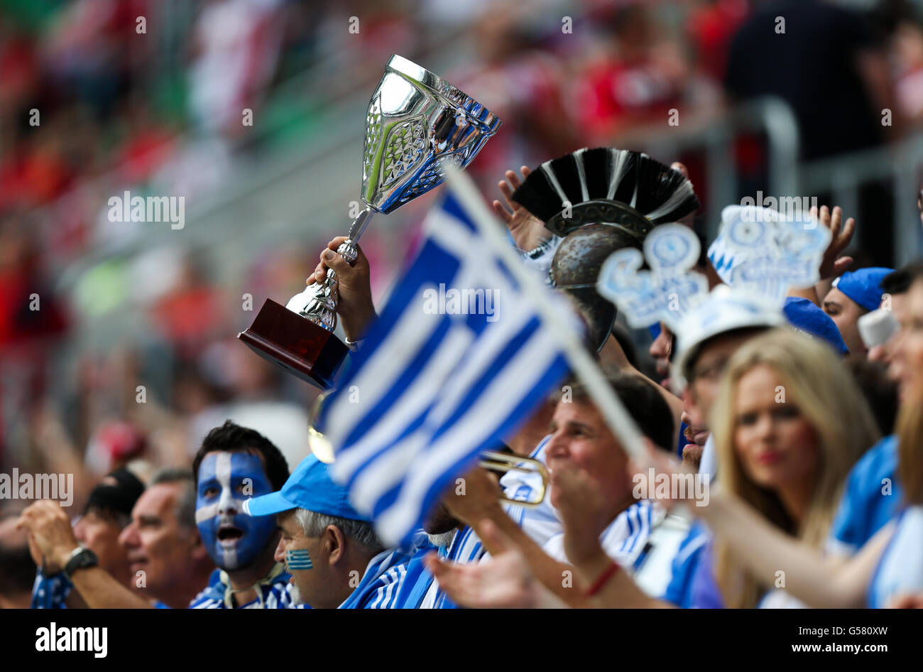 Trophy is held aloft in the by greek fan hi-res stock photography and ...