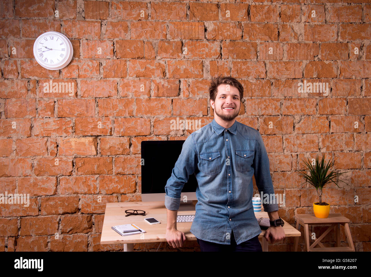 Business person sitting on office desk wearing smart watch Stock Photo ...