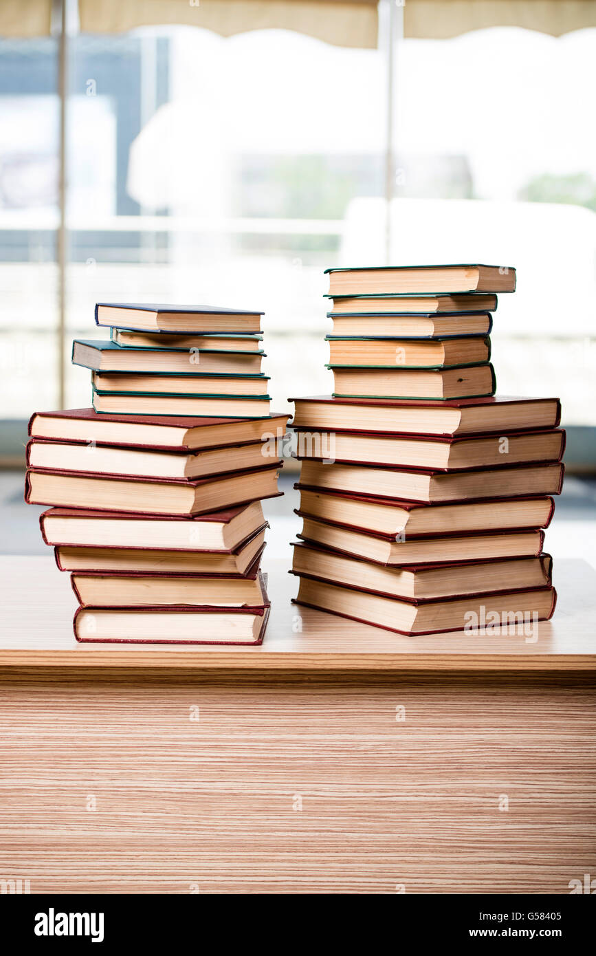 Stack of books arranged the office desk Stock Photo - Alamy