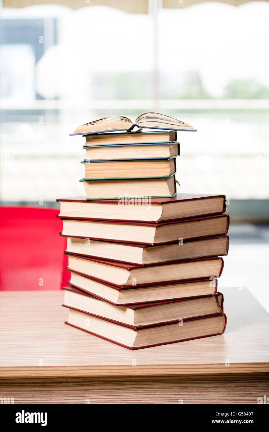 Stack of books arranged the office desk Stock Photo - Alamy