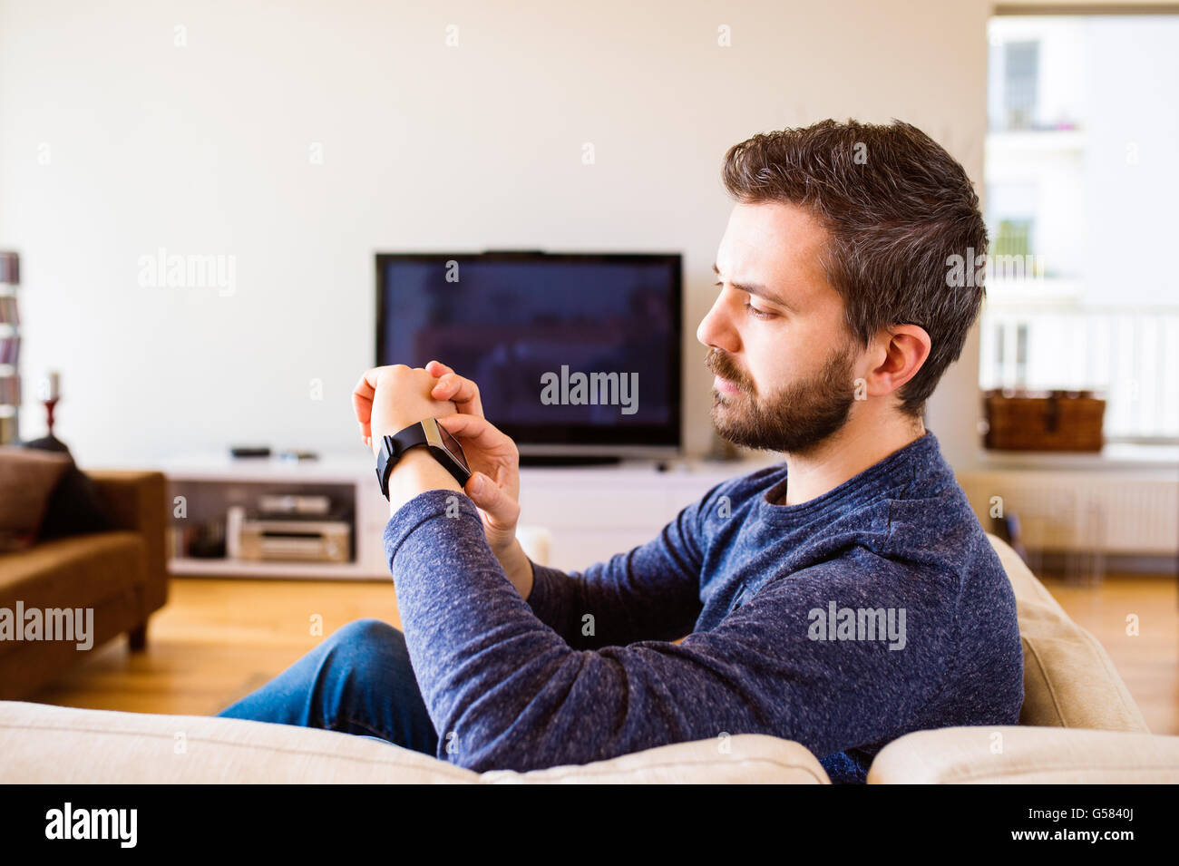 Man working from home using smart watch, living room Stock Photo - Alamy