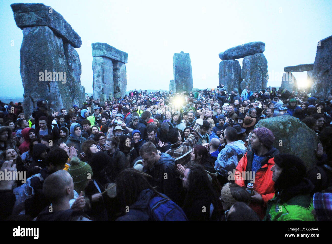 Summer Solstice at Stonehenge. Crowds at dawn amongst the stones at ...