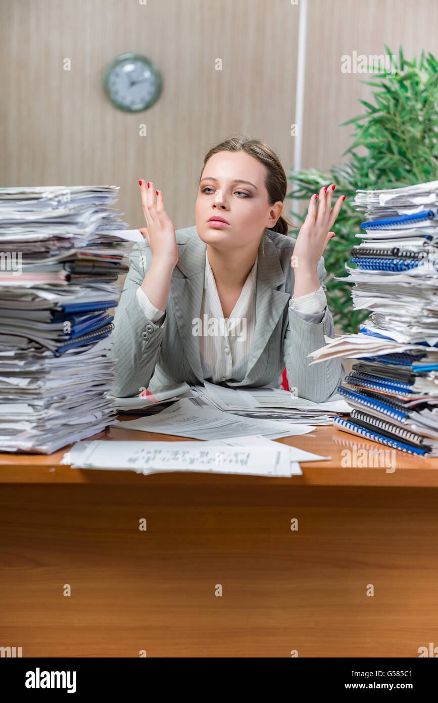 Woman under stress from excessive paper work Stock Photo - Alamy