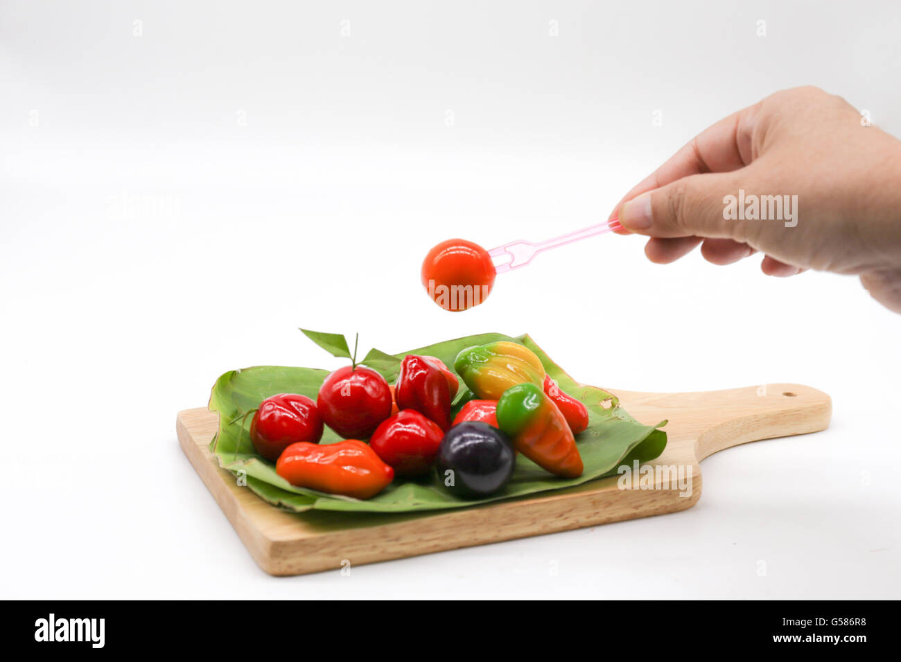Deletable imitation fruits on banana leaf Stock Photo - Alamy
