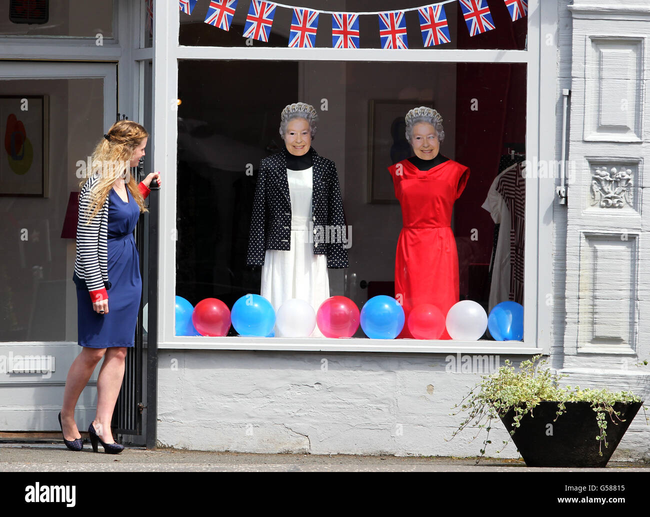 Chloe McCaig, adjusts her window display at Ruban Rouge Boutique in ...