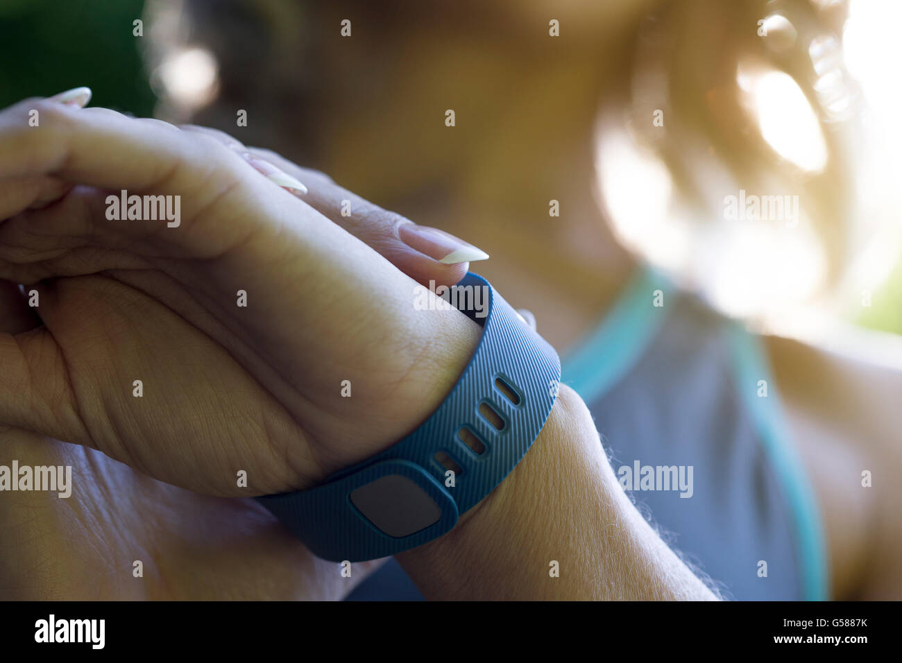 Young woman using a fitness watch Stock Photo - Alamy