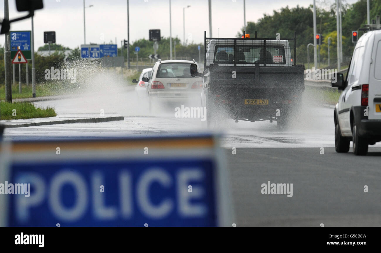 Cars splash through remaining flood water on the A63 outside Leeds ...